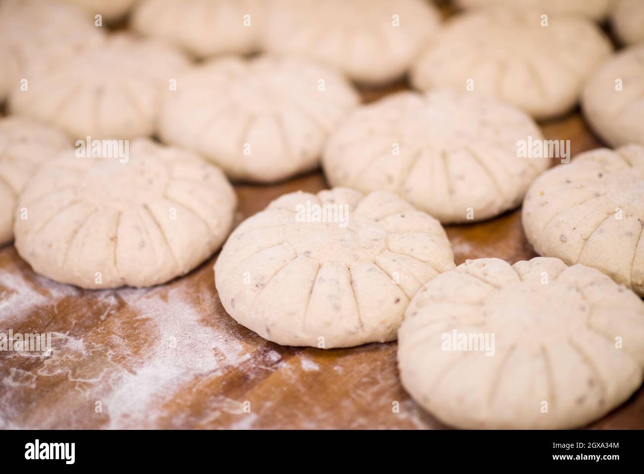 balls of dough bread getting ready to be baked at professional bakery ...