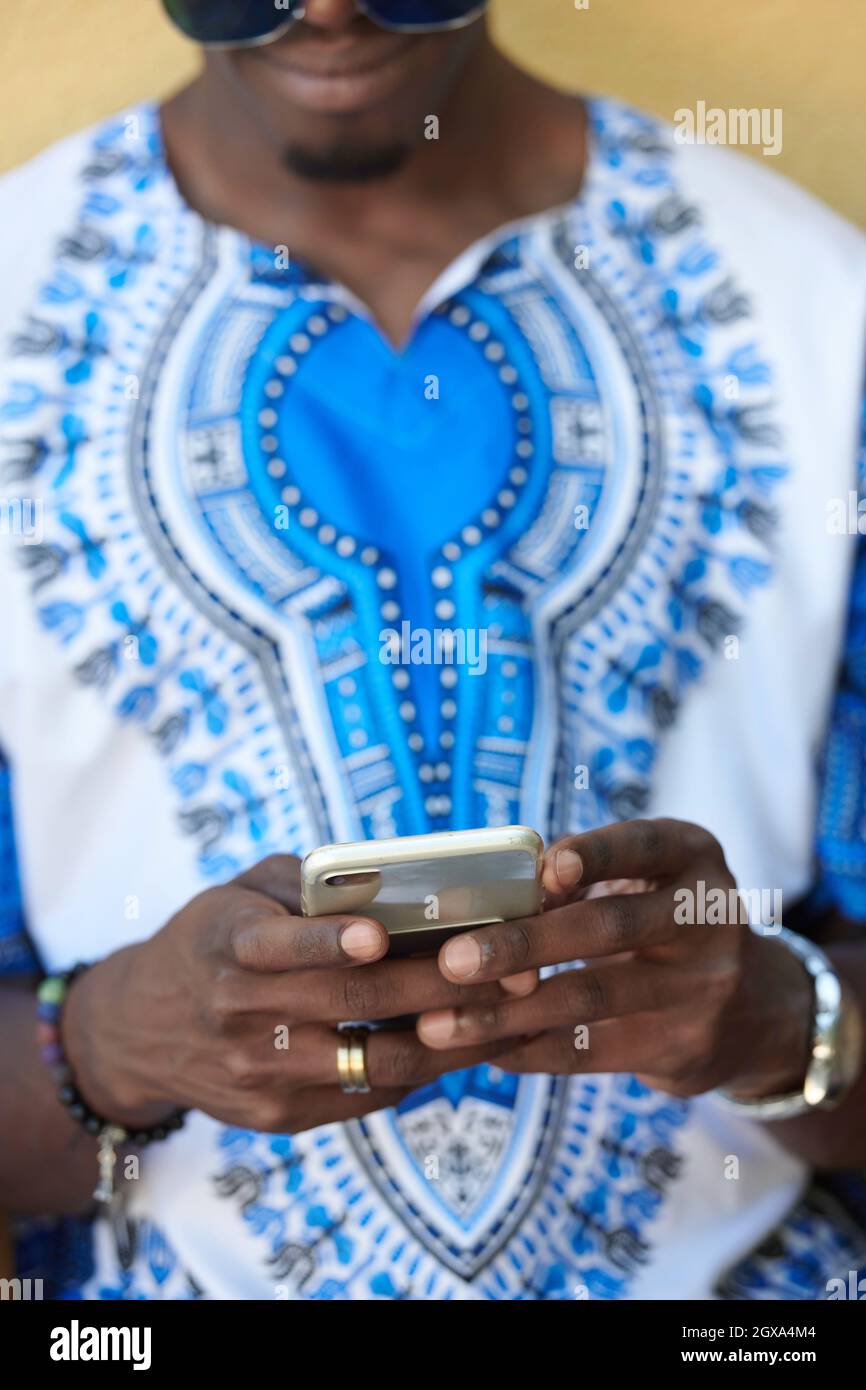 Native Sudan black african man using smart phone and wearing ...