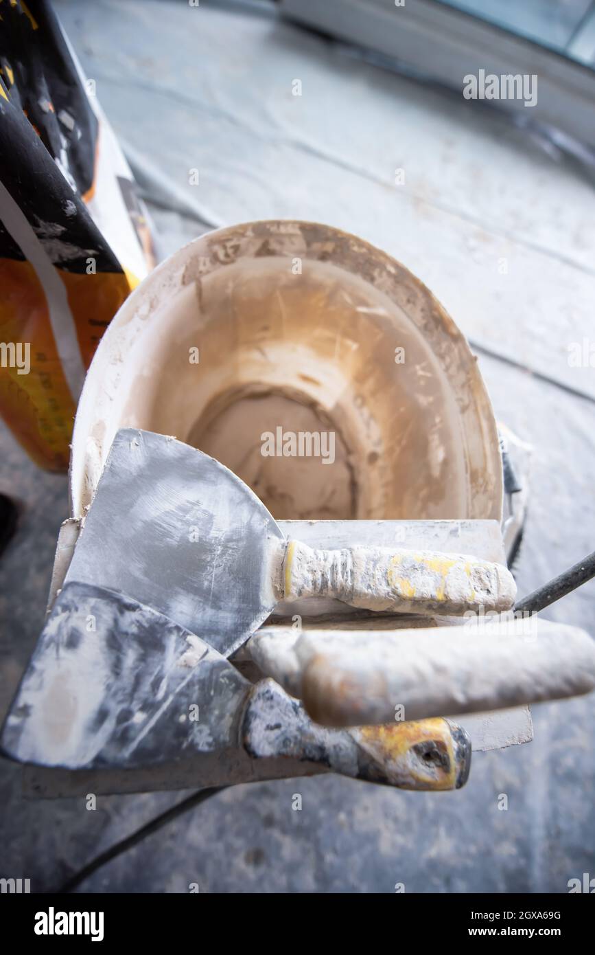 Top view of construction tools in bucket on concrete background. Set of ...