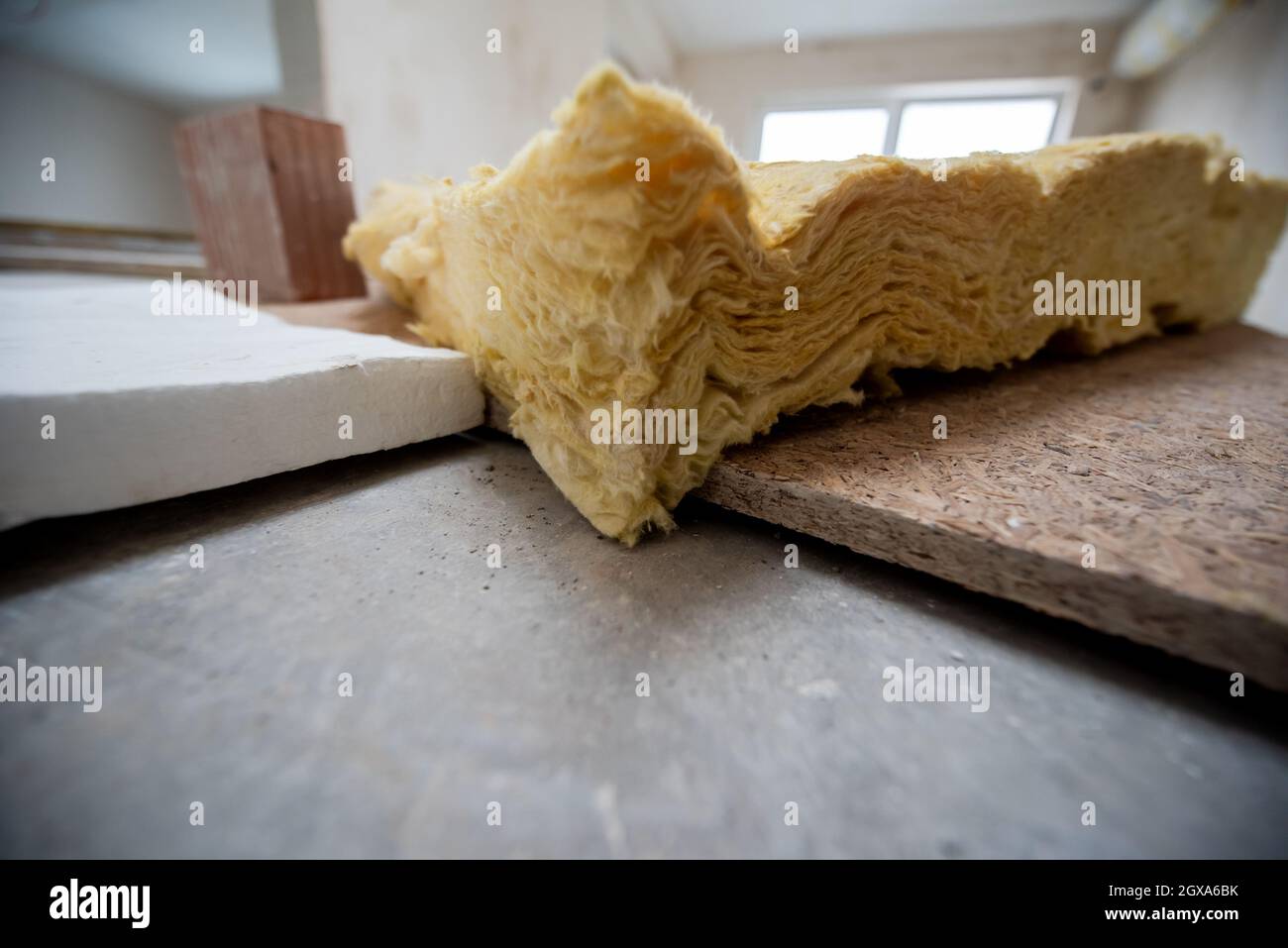 red Bricks and glass wool laying on the concrete floor at construction ...