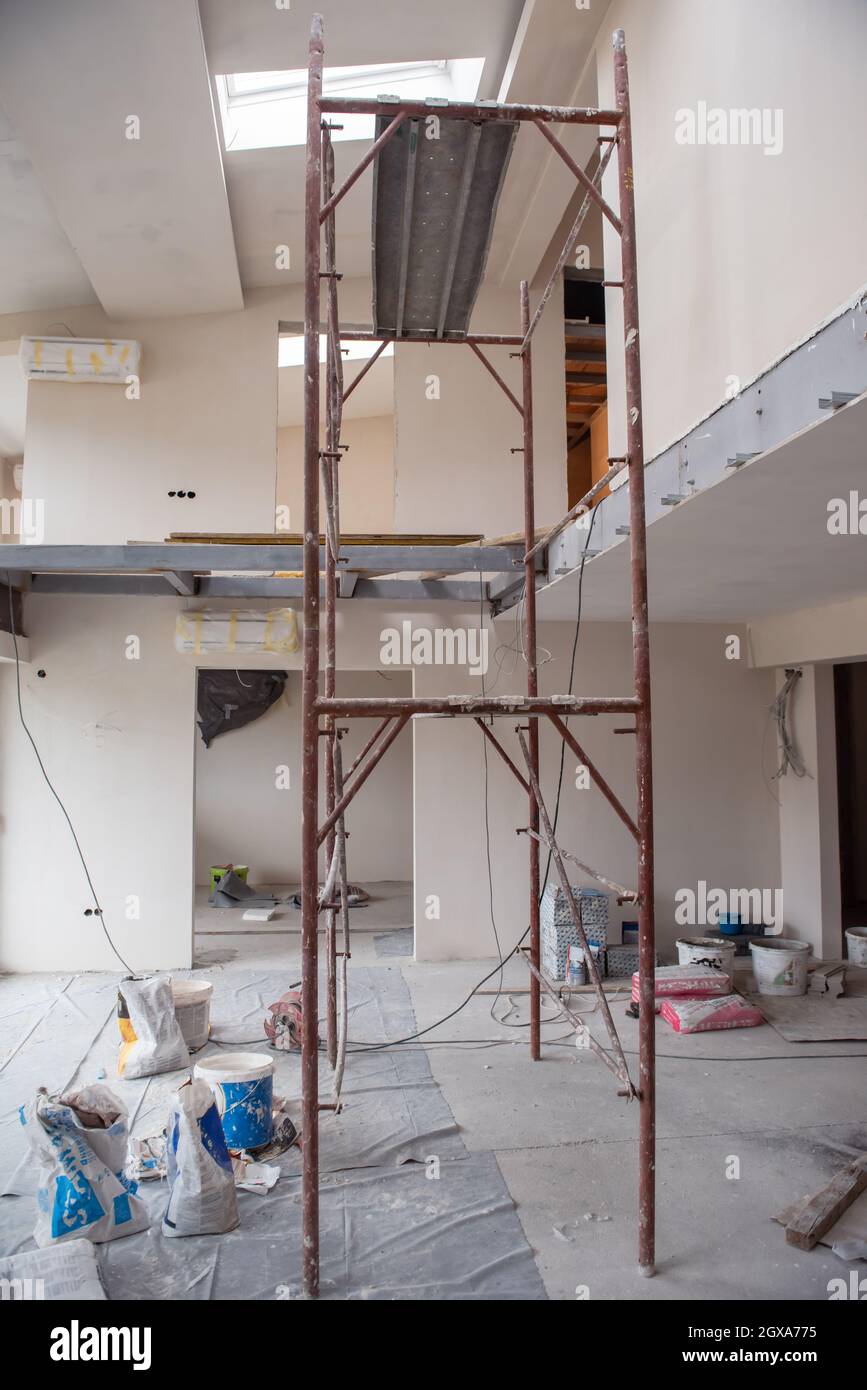 interior of construction site with scaffolding in a large modern ...