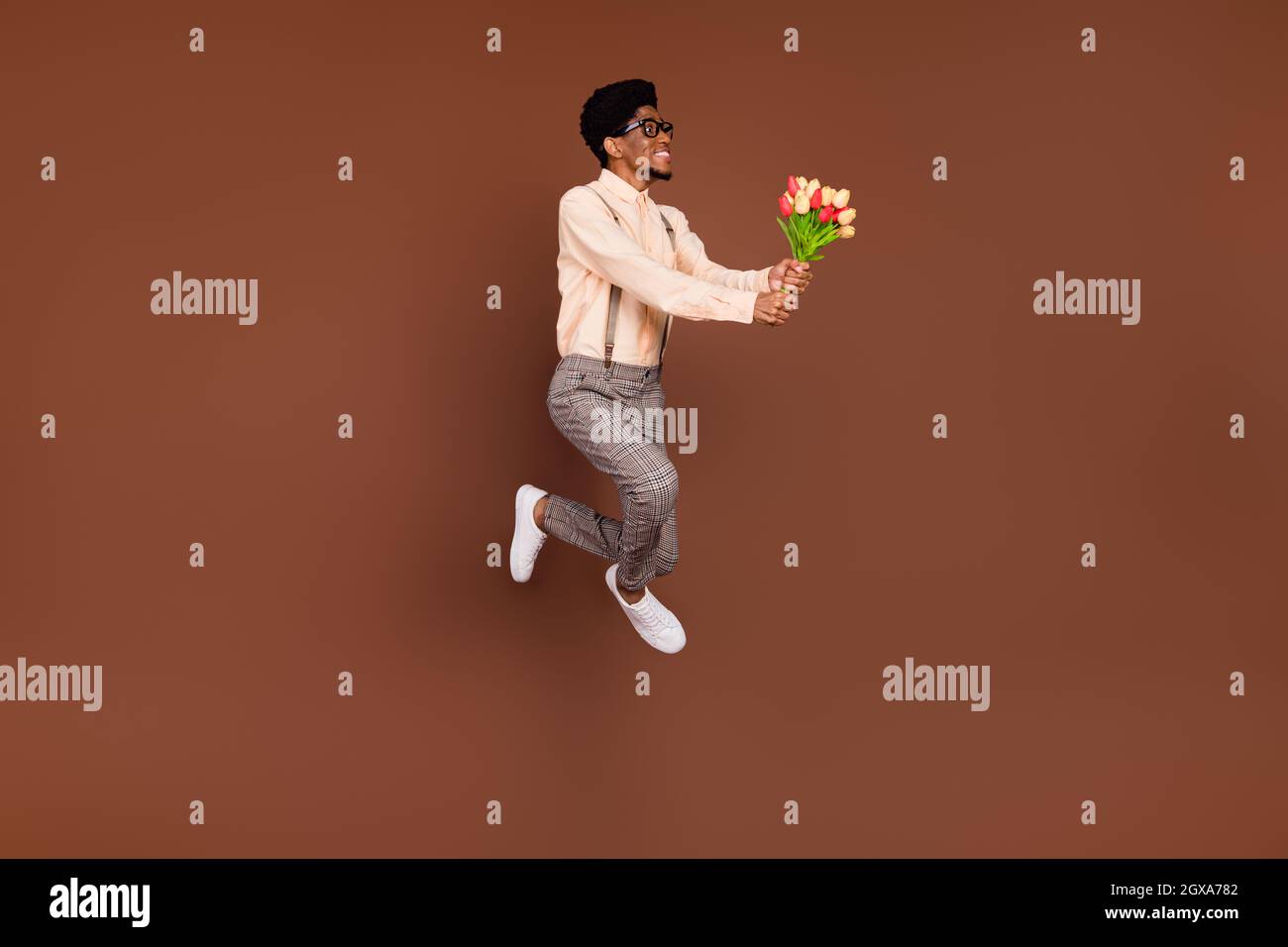 Profile photo of geek boyfriend guy jump carry bunch flowers run wear ...