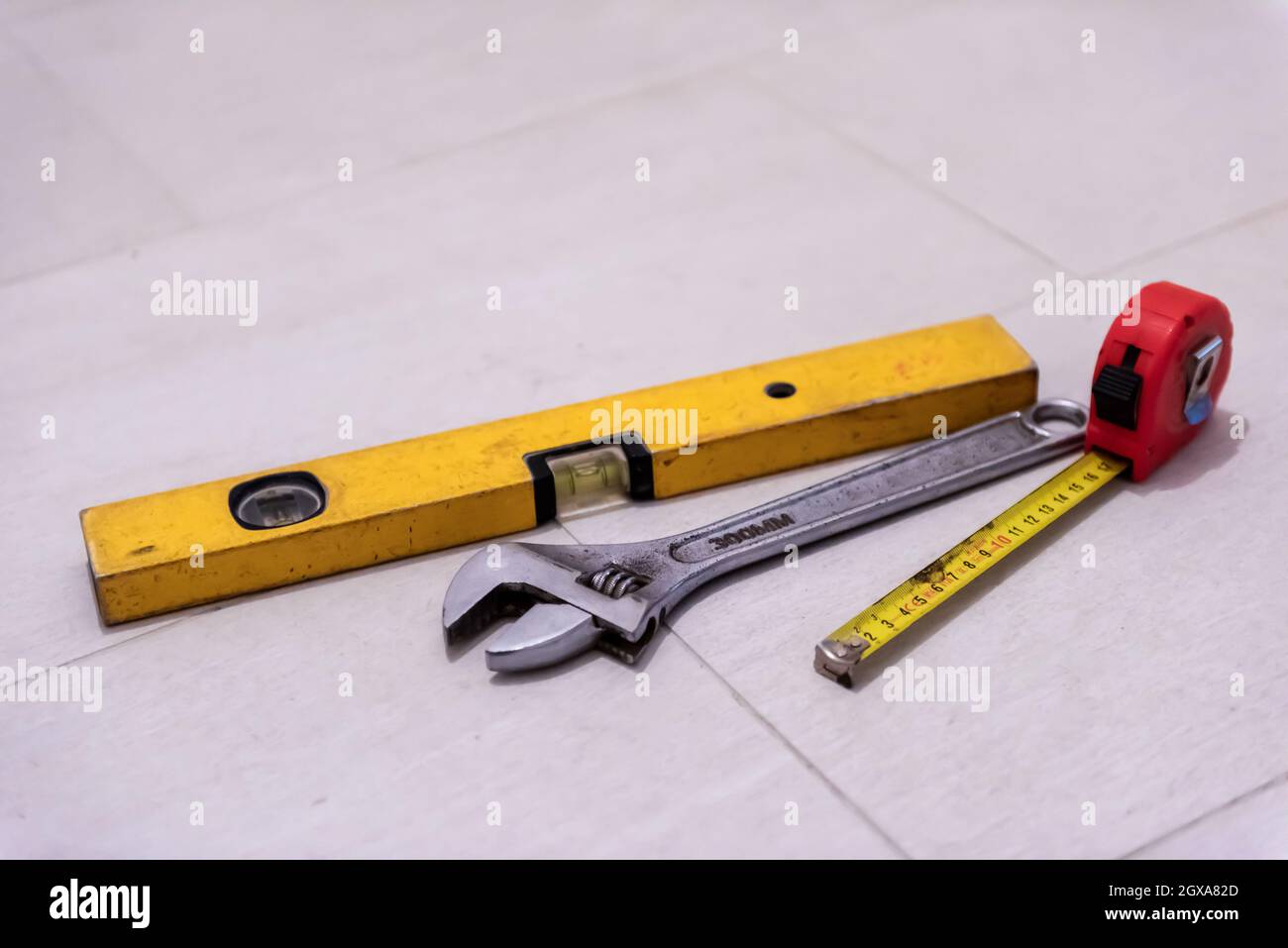 set of hand working tools on ceramic tile background The concept of ...
