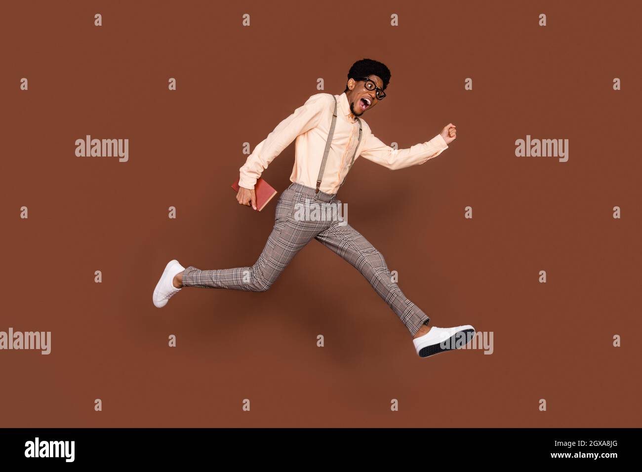 Full length body size view of nice cheerful guy nerd jumping holding ...