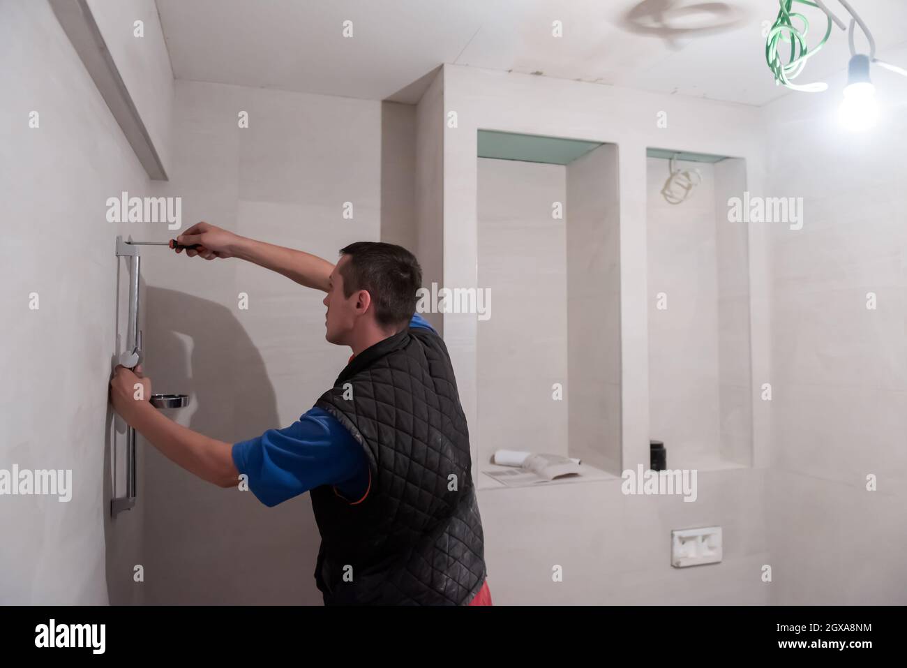 professional plumber working in a bathroom, plumbing repair service ...