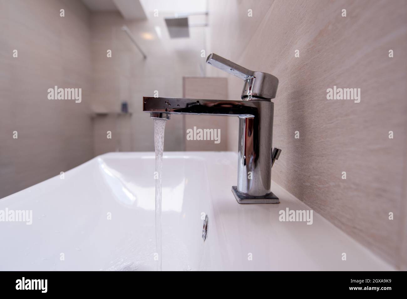 Open Water Faucet with flowing water at luxury bathroom Stock Photo - Alamy