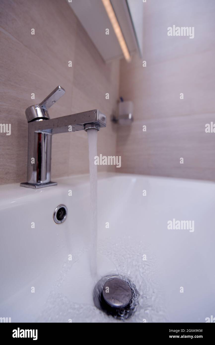 Open Water Faucet with flowing water at luxury bathroom Stock Photo - Alamy