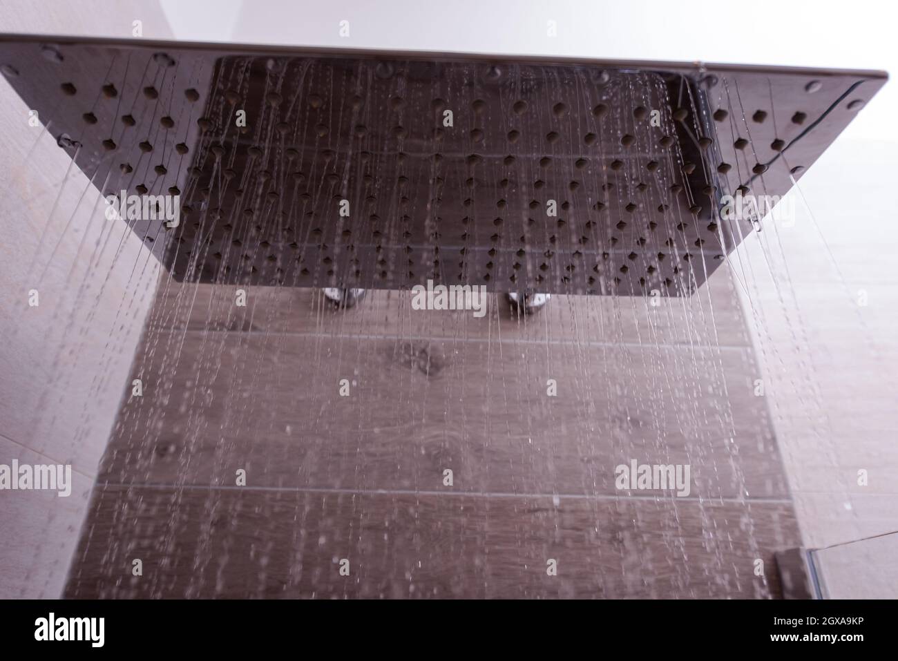 Modern elegant stainless steel shower with water drops in bath interior ...