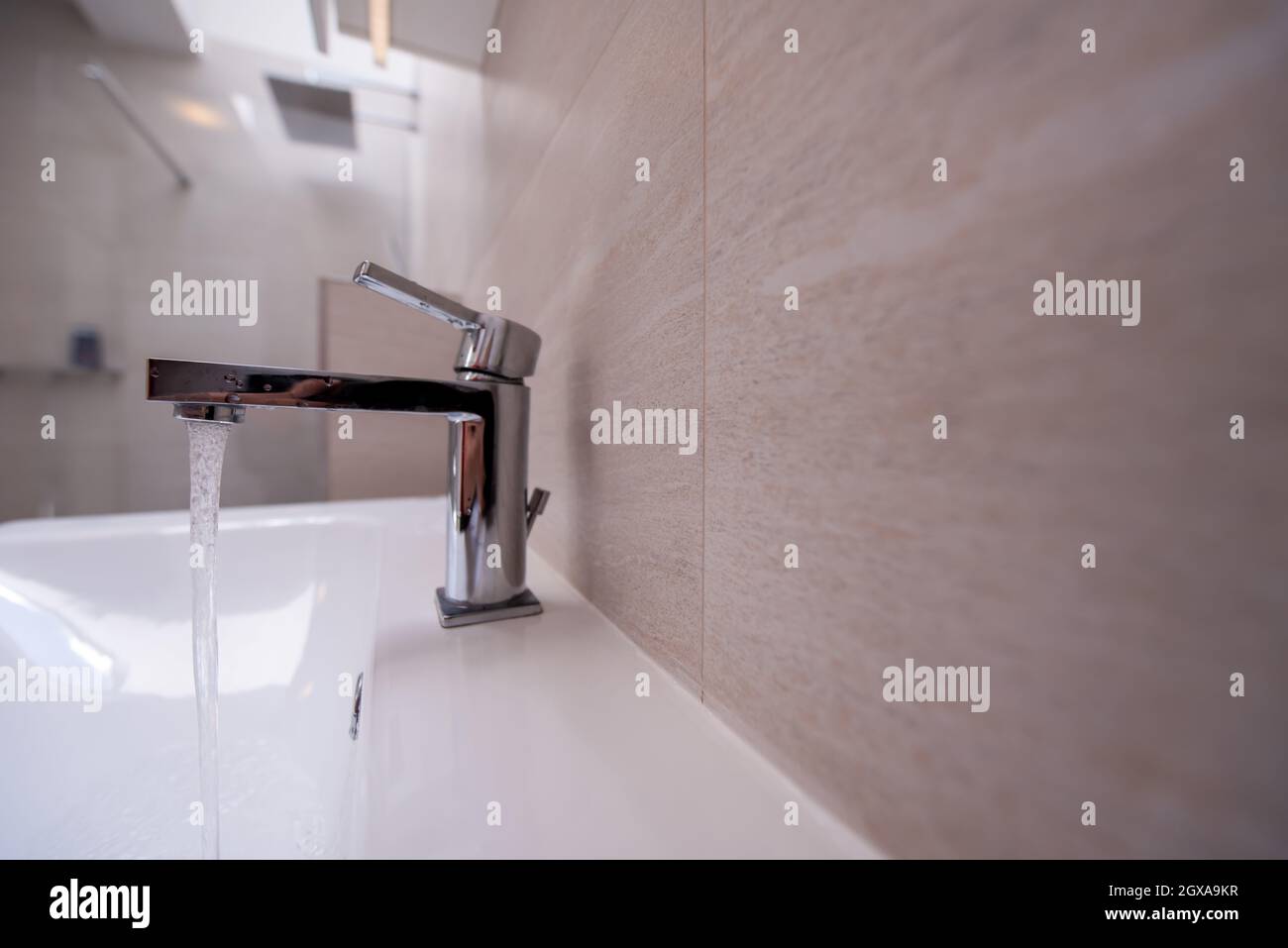 Open Water Faucet with flowing water at luxury bathroom Stock Photo - Alamy