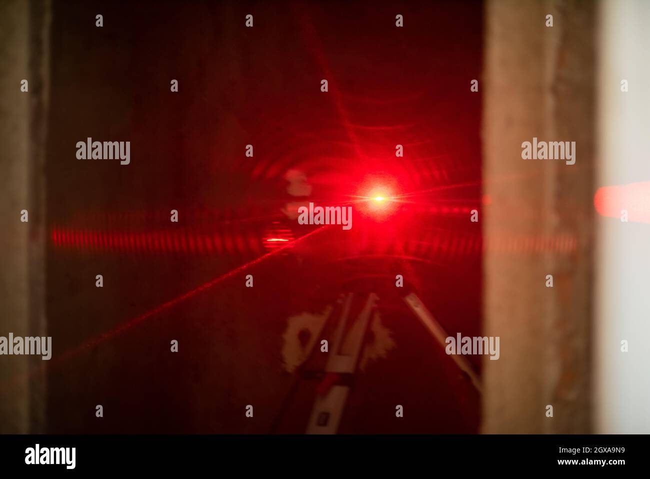 professional worker using laser level in a building under construction ...