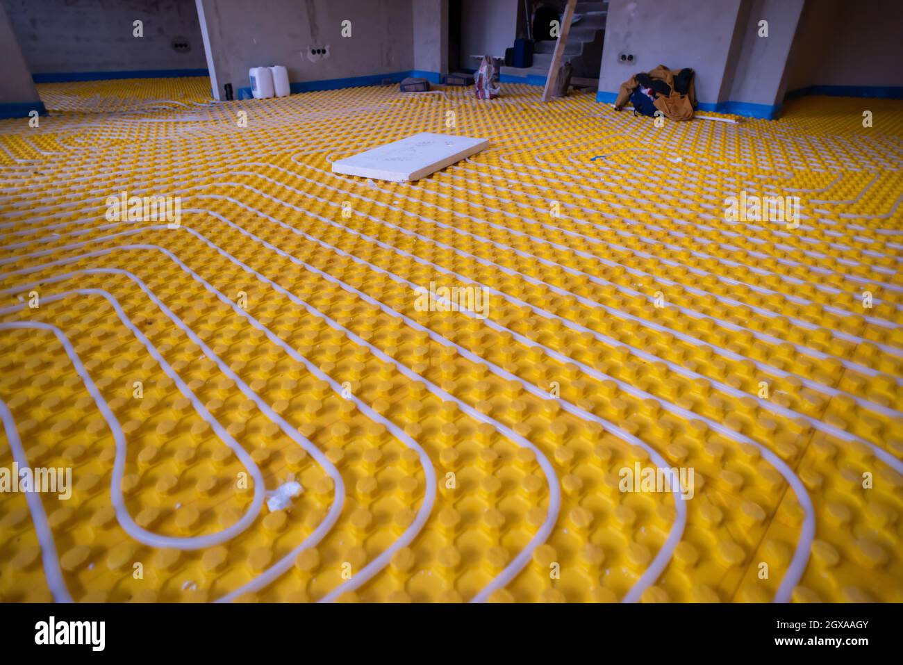 yellow underfloor heating installation with white polyethylene pipes on ...