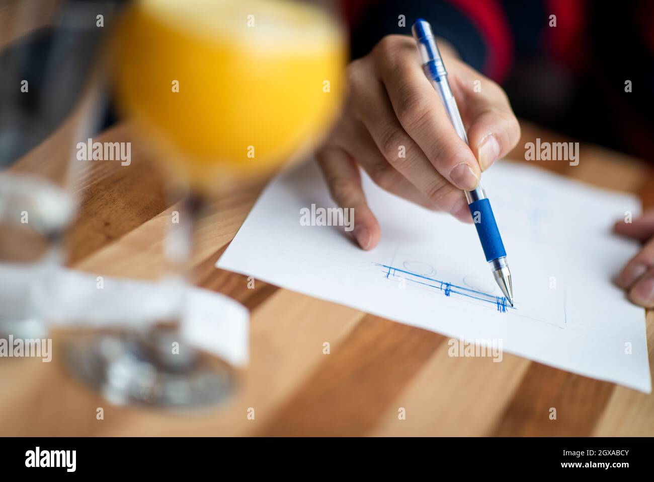 The hand of the designer with a pen, designing and sketching his idea ...