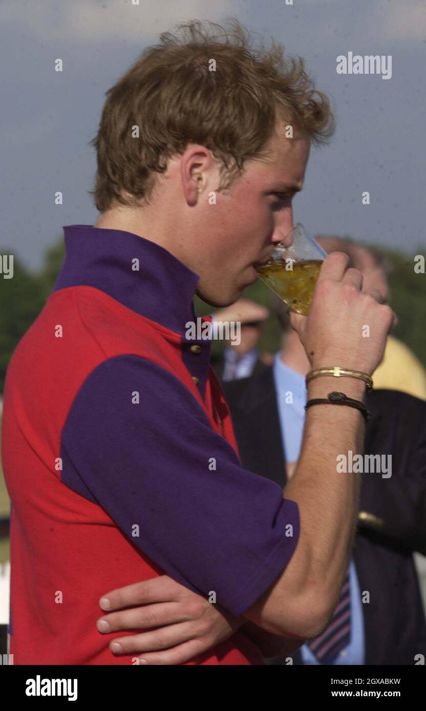Prince William has a refreshing drink during a polo match at Windsor ...