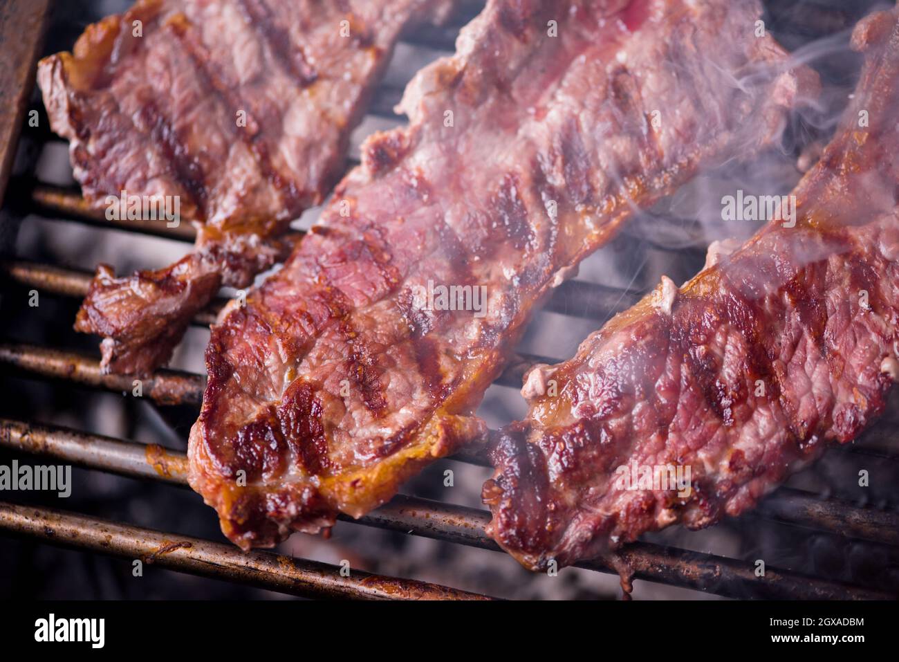 Assorted delicious grilled meat over the coals on barbecue Stock Photo ...
