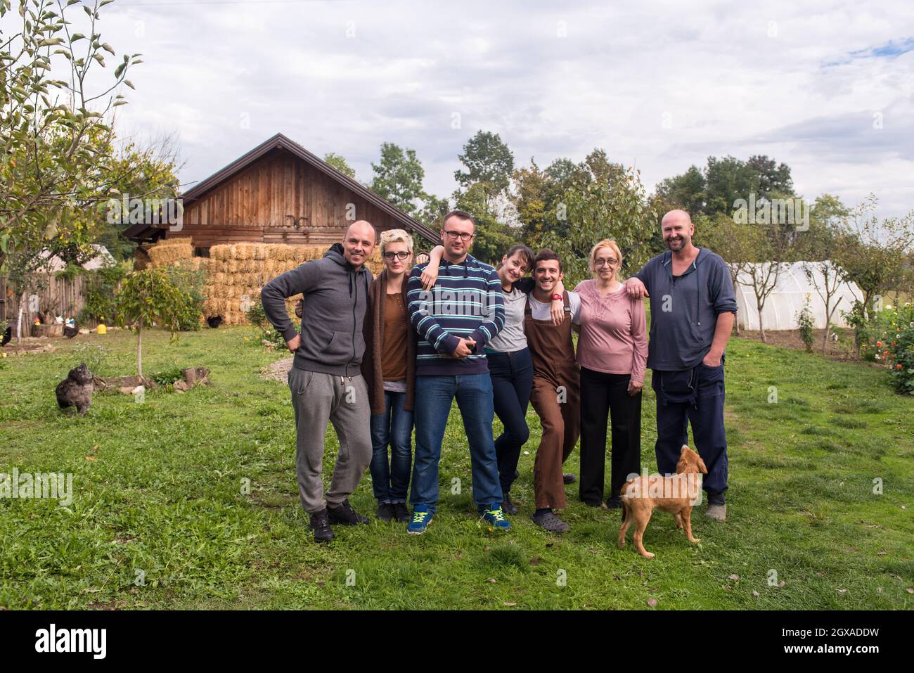 portrait of happy three generations family with dog at beautiful ...