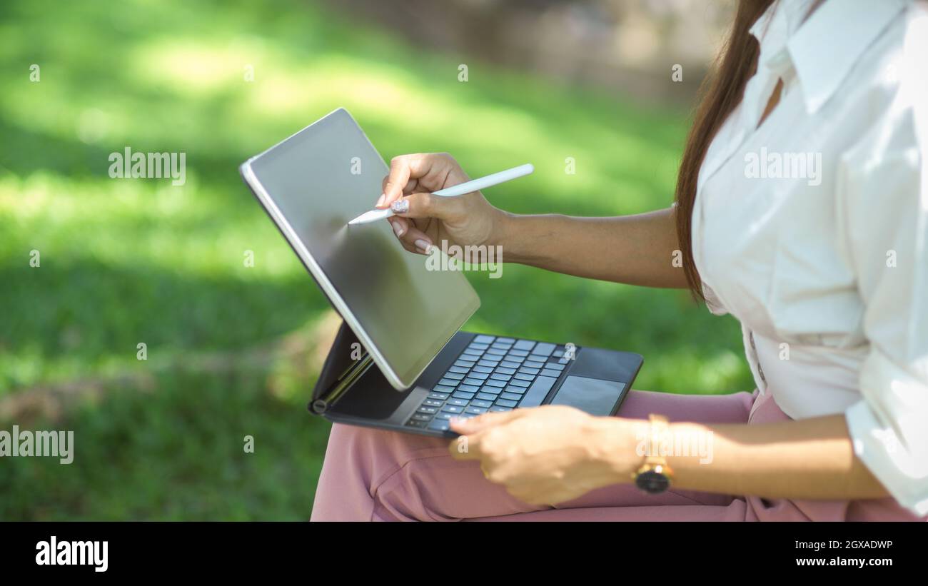 Female write her ideas on digital tablet, finding an inspiration and ...