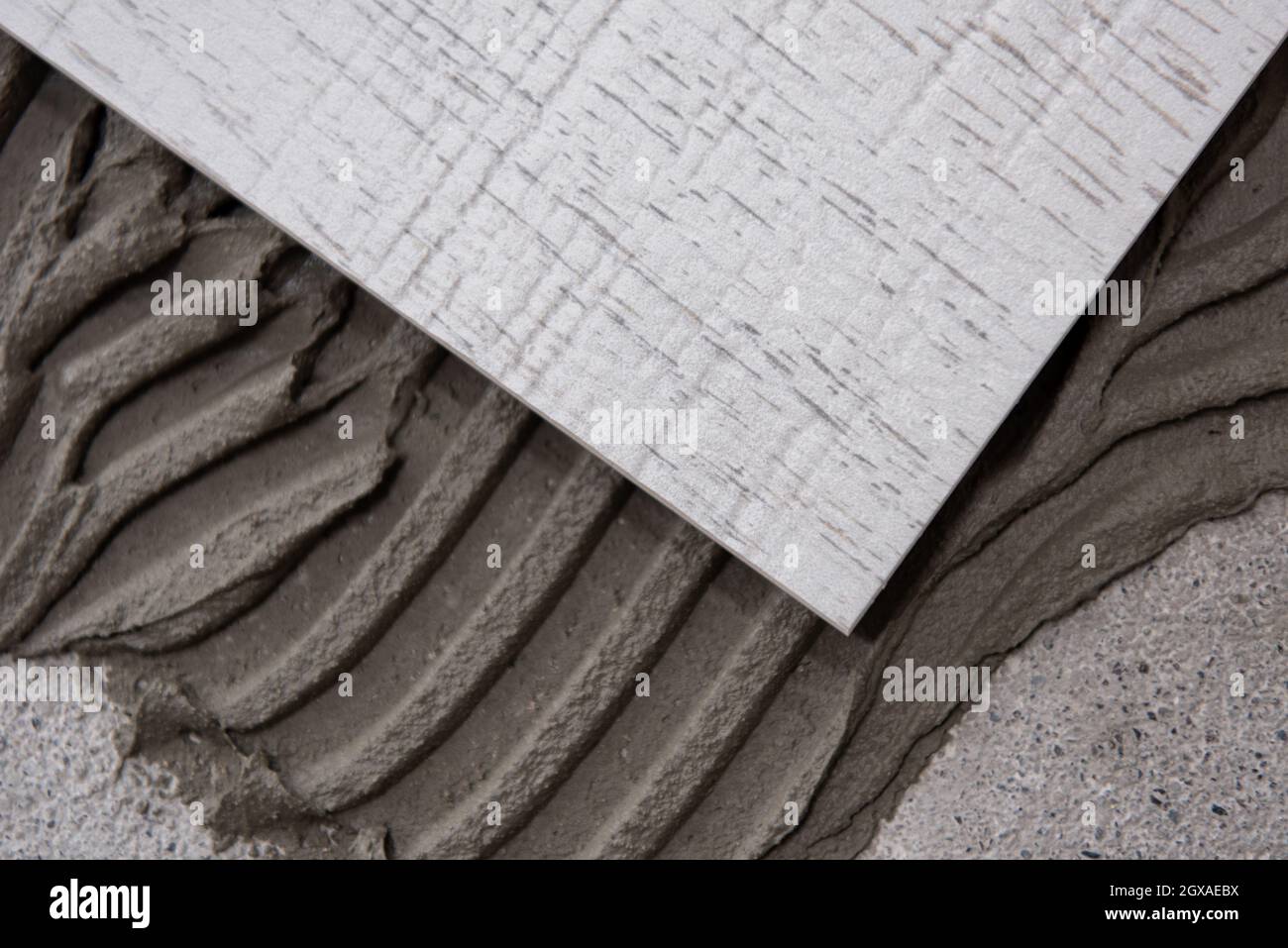 Ceramic wood effect tiles and tools for tiler on the floor unfinished ...