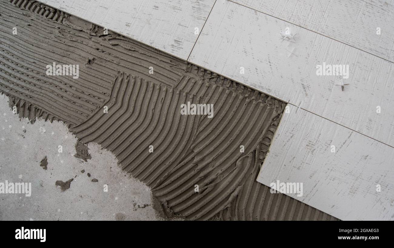 Ceramic wood effect tiles and tools for tiler on the floor unfinished ...