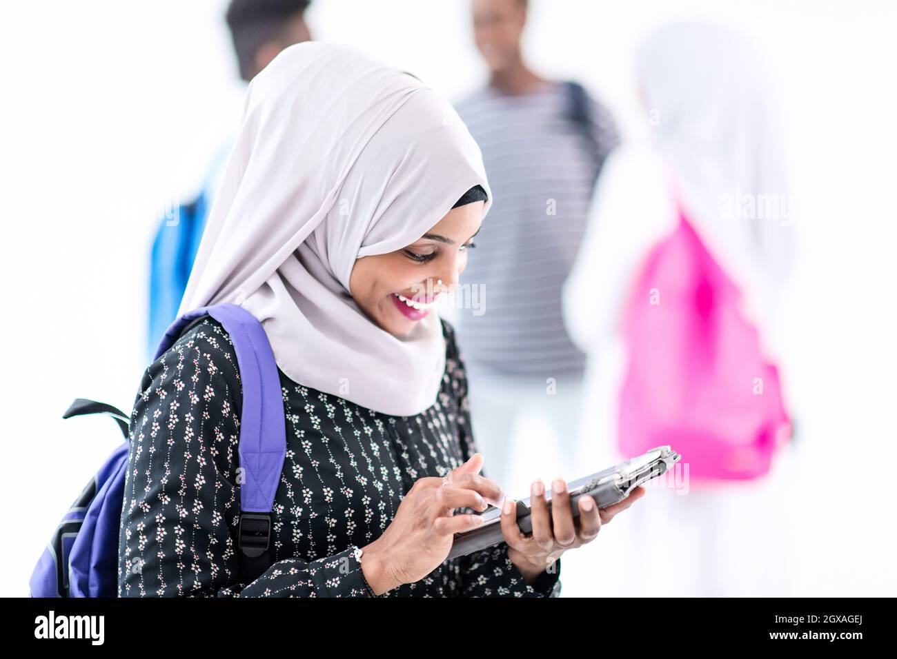 young modern muslim african female student using tablet computer with ...
