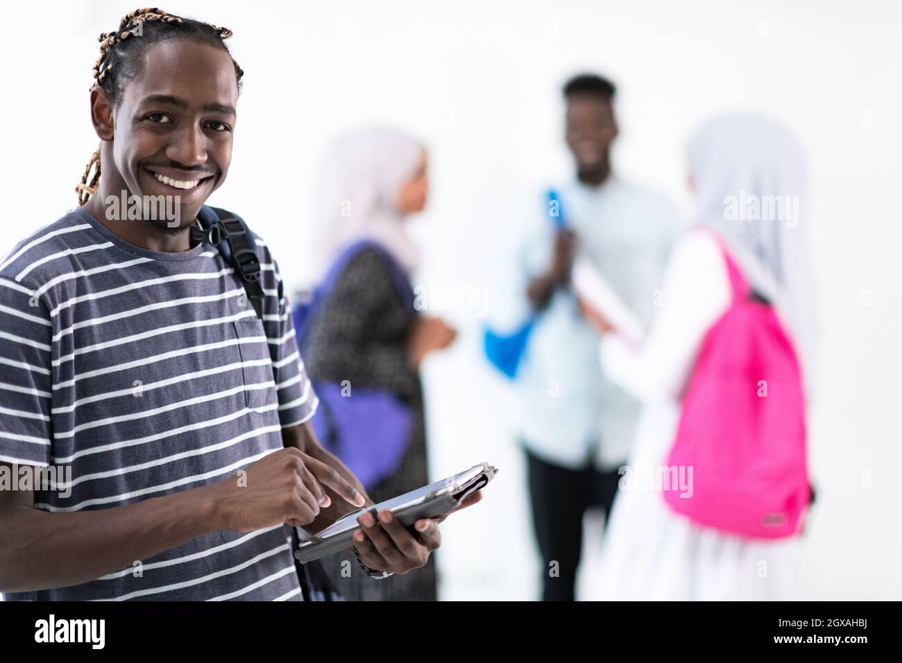 university lifestyle handsome young african student man holding tablet ...