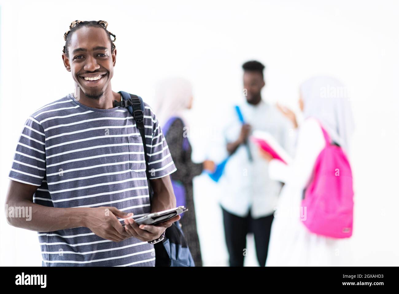 university lifestyle handsome young african student man holding tablet ...