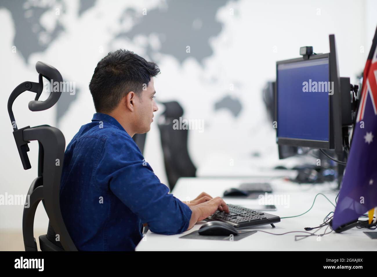 casual indian business man working on desktop computer in modern open ...