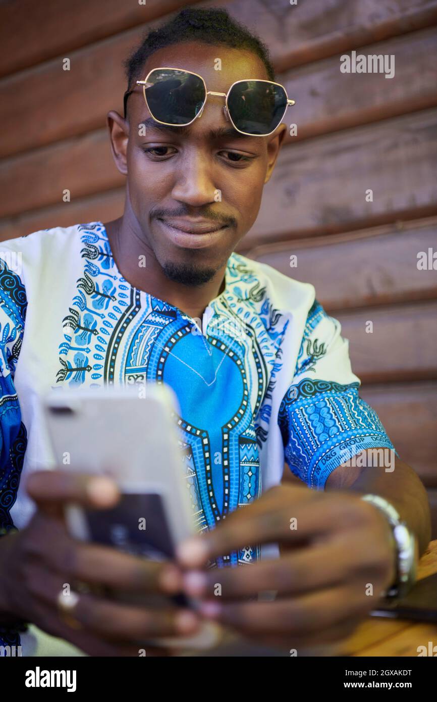 Native Sudan black african man using smart phone and wearing ...