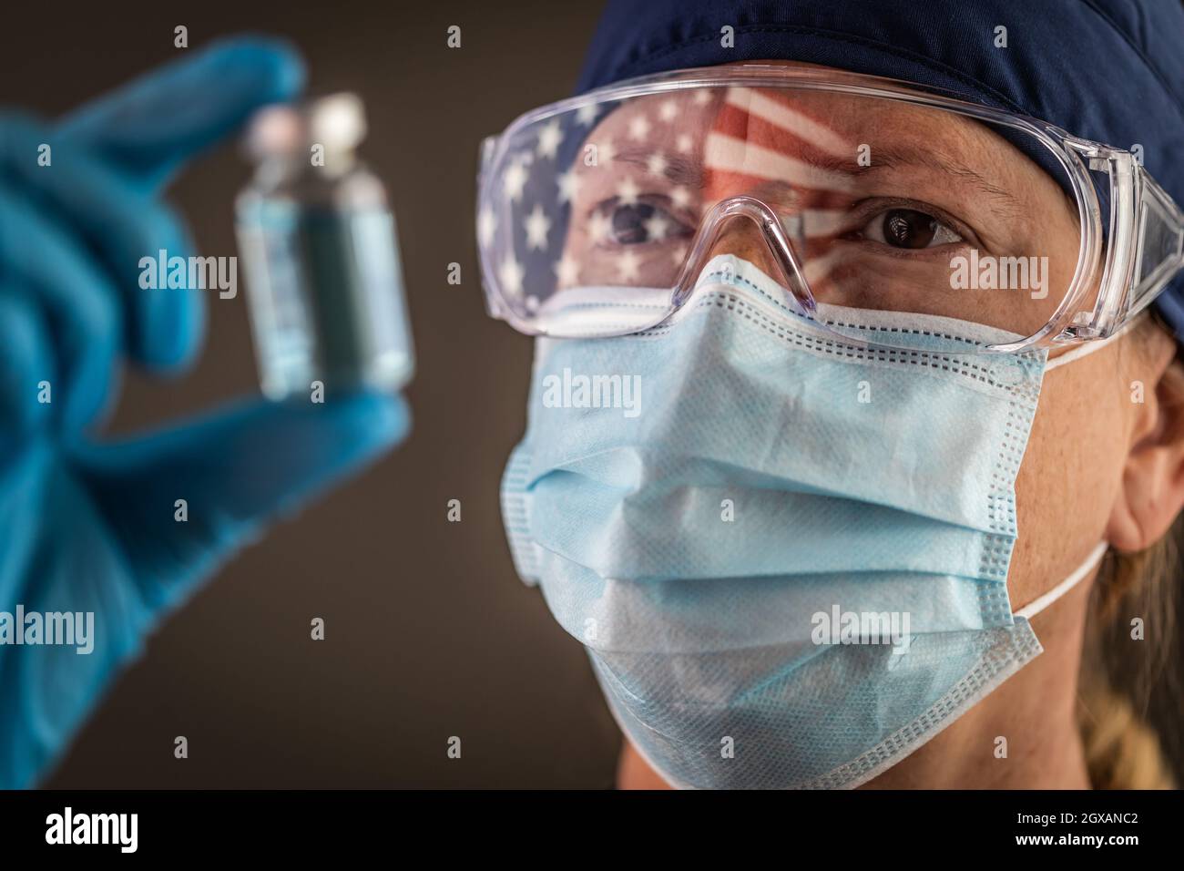 American Flag Reflecting on Female Medical Worker Holding Vaccine Vial ...