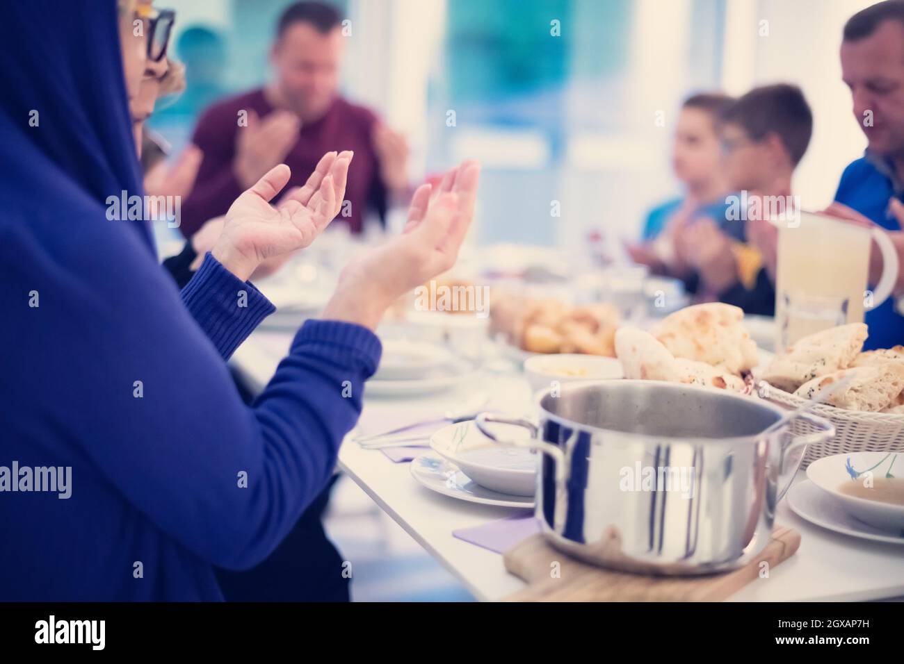 Eid Mubarak Muslim people praying before iftar dinner. Eating ...