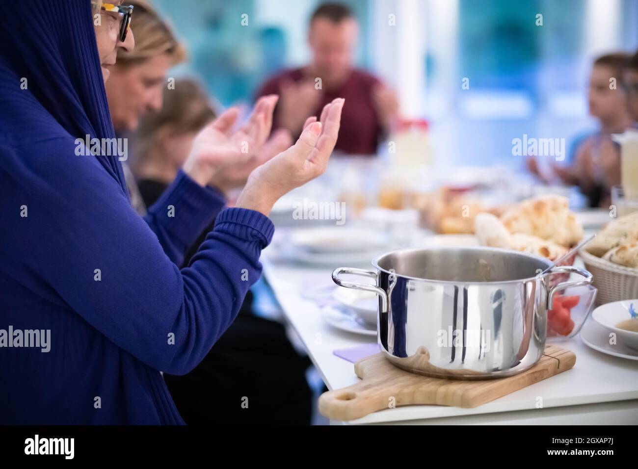 Eid Mubarak Muslim people praying before iftar dinner. Eating ...