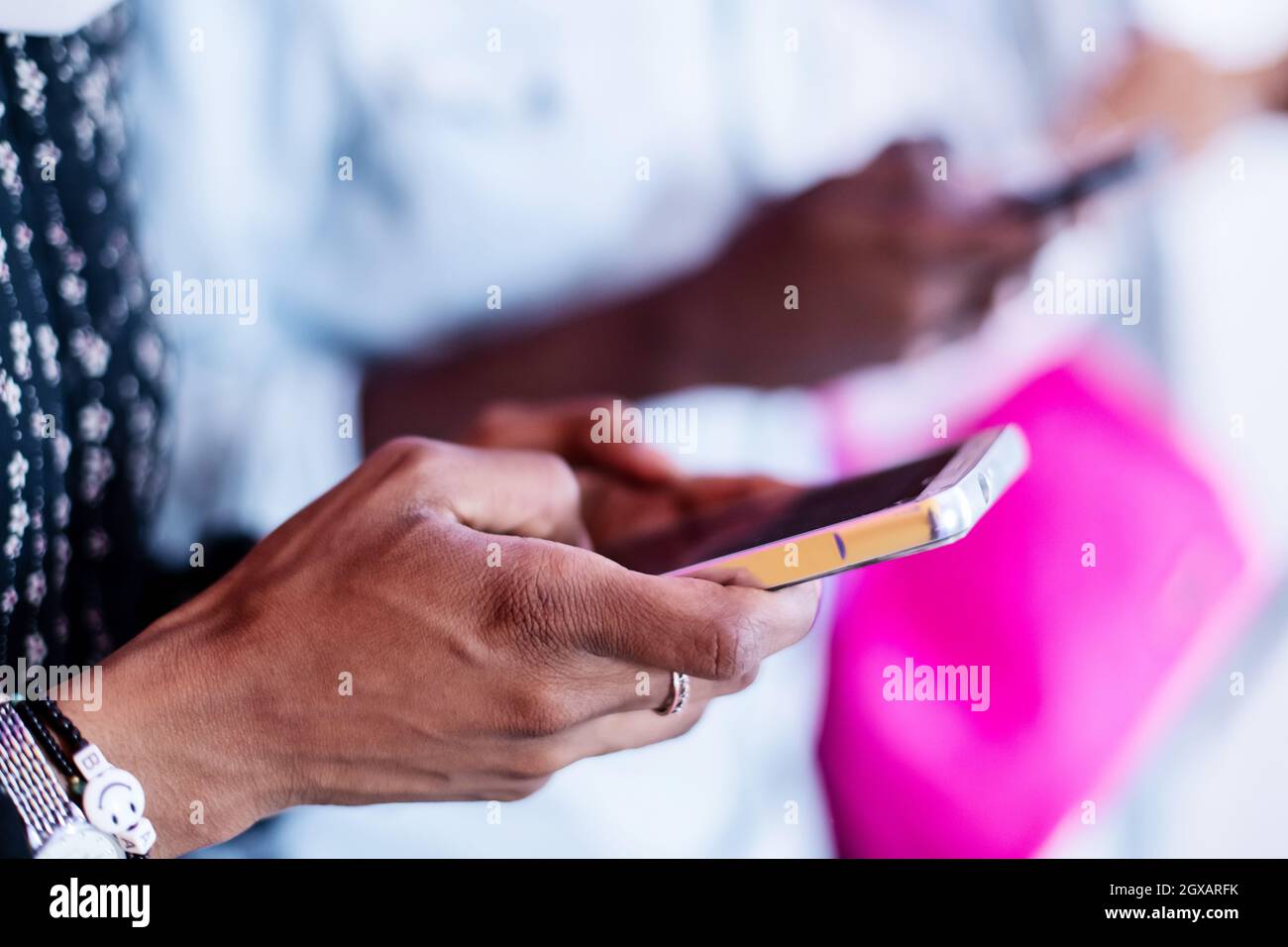 african students group using smart phones with plastic pink background ...