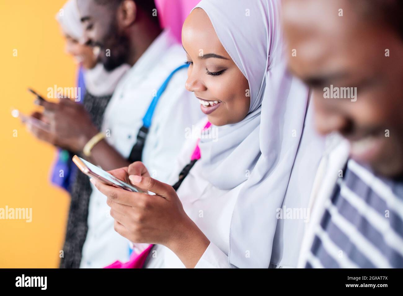 african students group using smart phones with plastic pink background ...