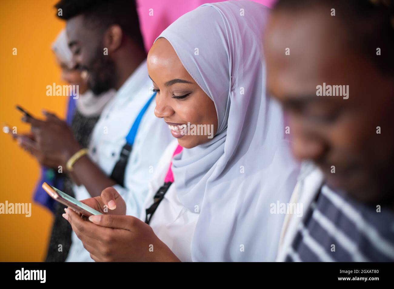 african students group using smart phones with plastic pink background ...