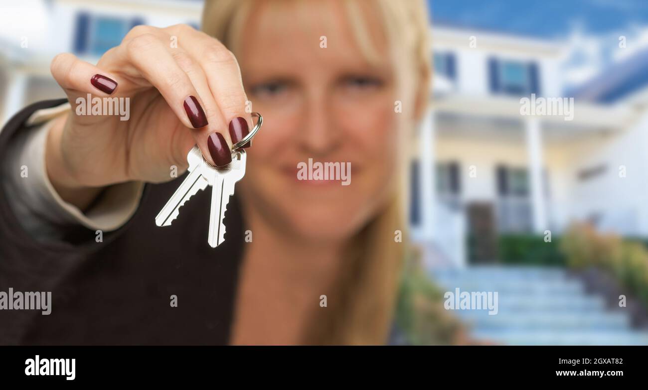 Real Estate Agent Handing Over New House Keys with House Behind Stock ...