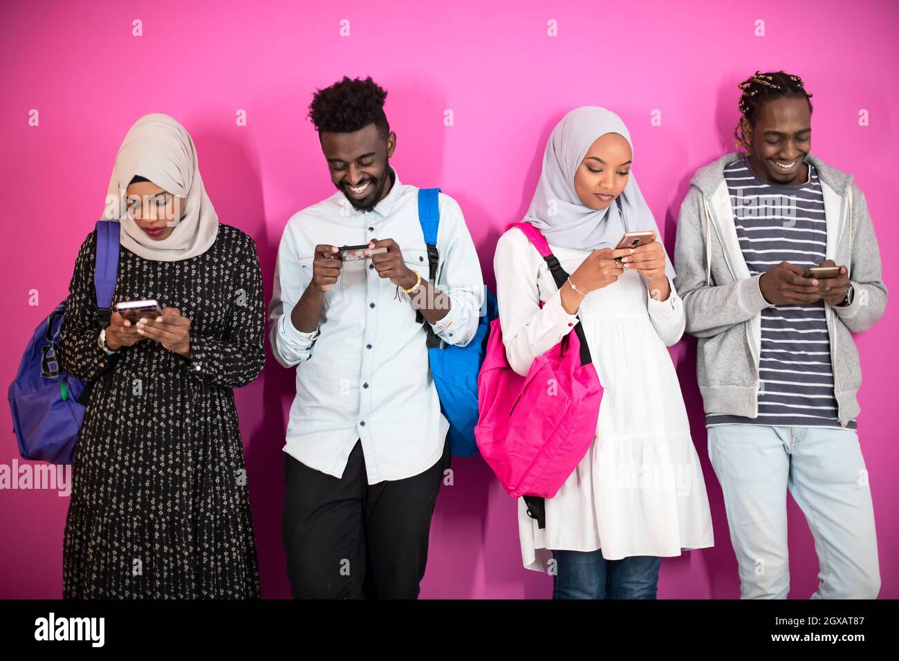 african students group using smart phones with plastic pink background ...