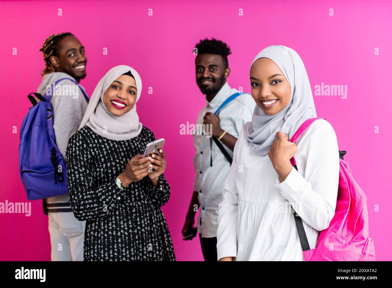 african students group using smart phones with plastic pink background ...