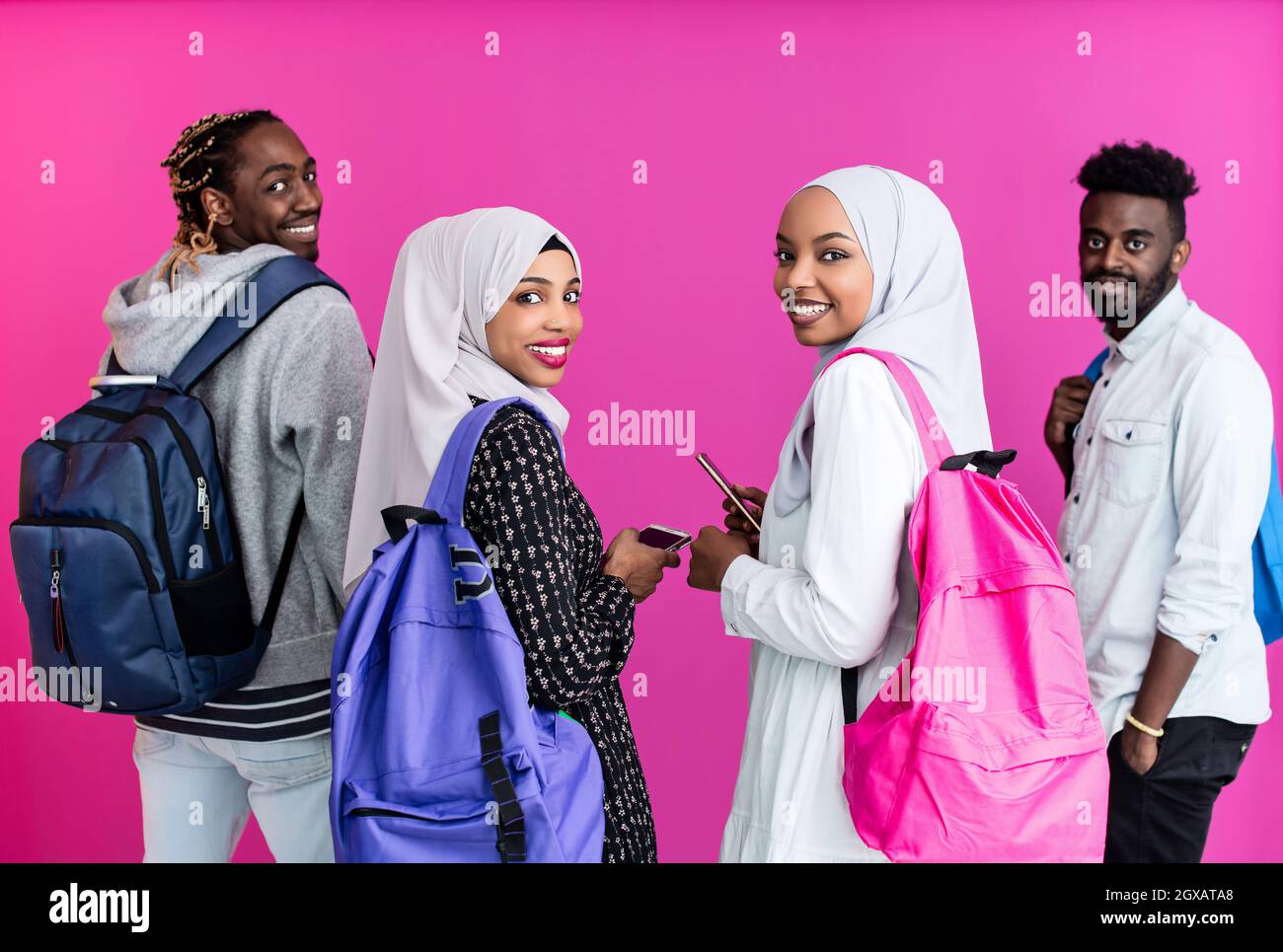 african students group using smart phones with plastic pink background ...
