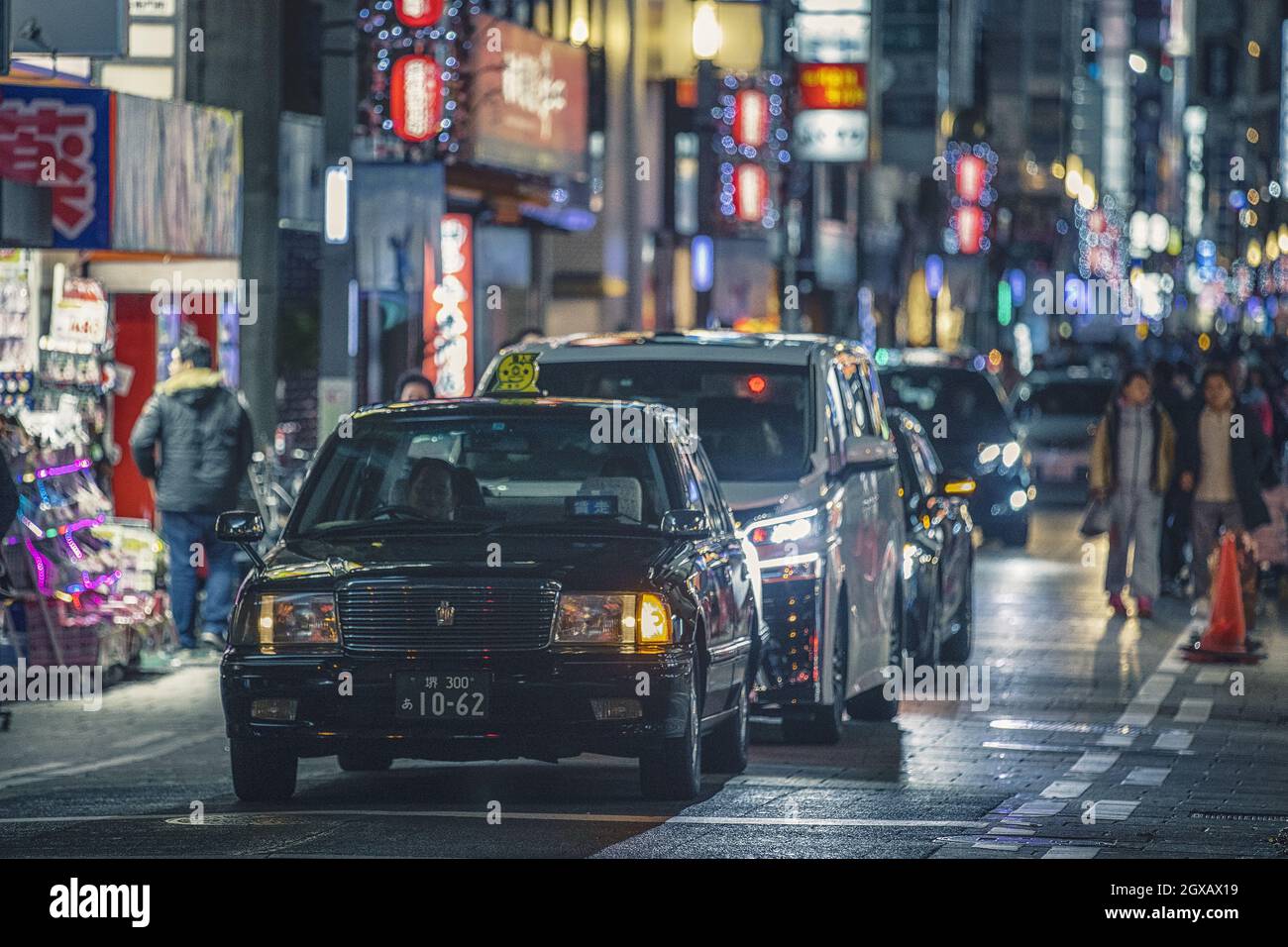 Mar 29, 2020: A night urban scenery of the cars driving in neon city ...