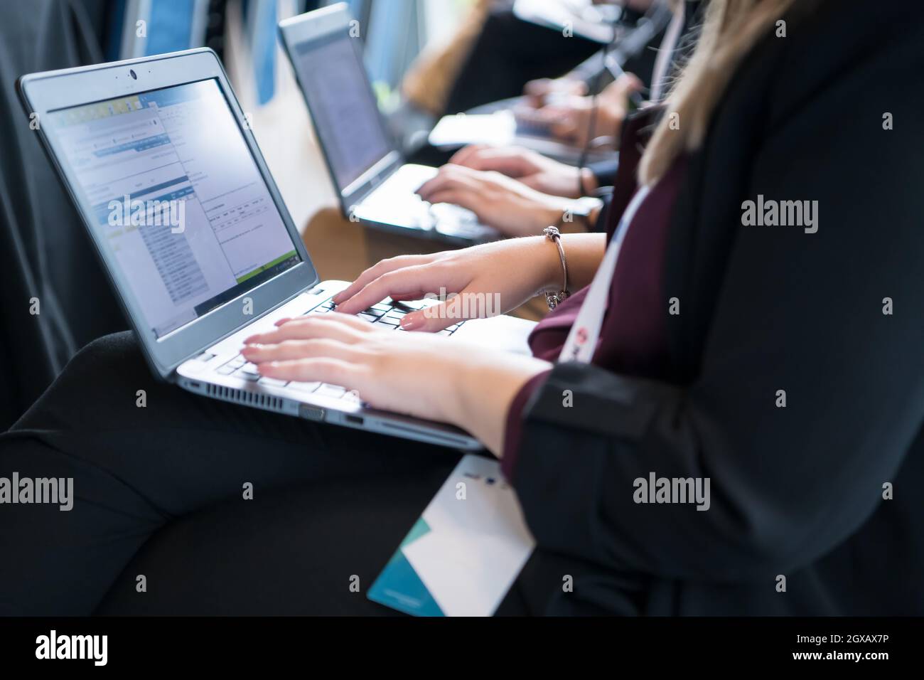close up shot of business people hands typing on laptop computer ...