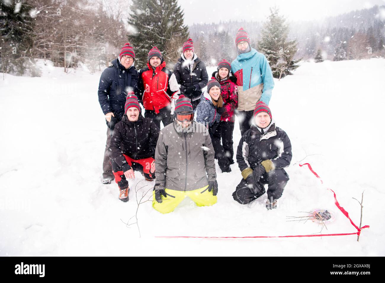 group portrait of young happy business people enjoying snowy winter day ...