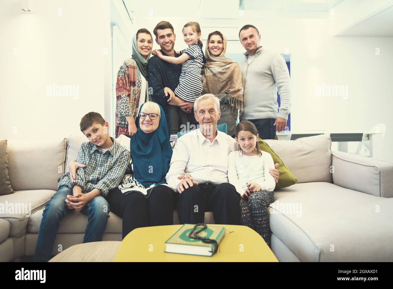 several generations portrait of happy modern muslim family before iftar ...
