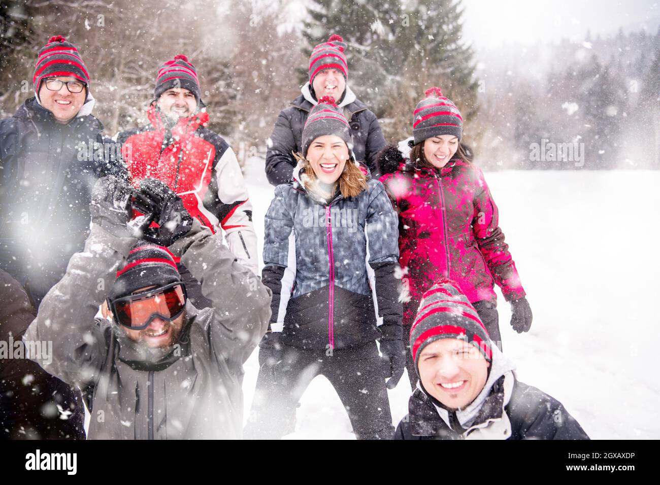 group portrait of young happy business people enjoying snowy winter day ...