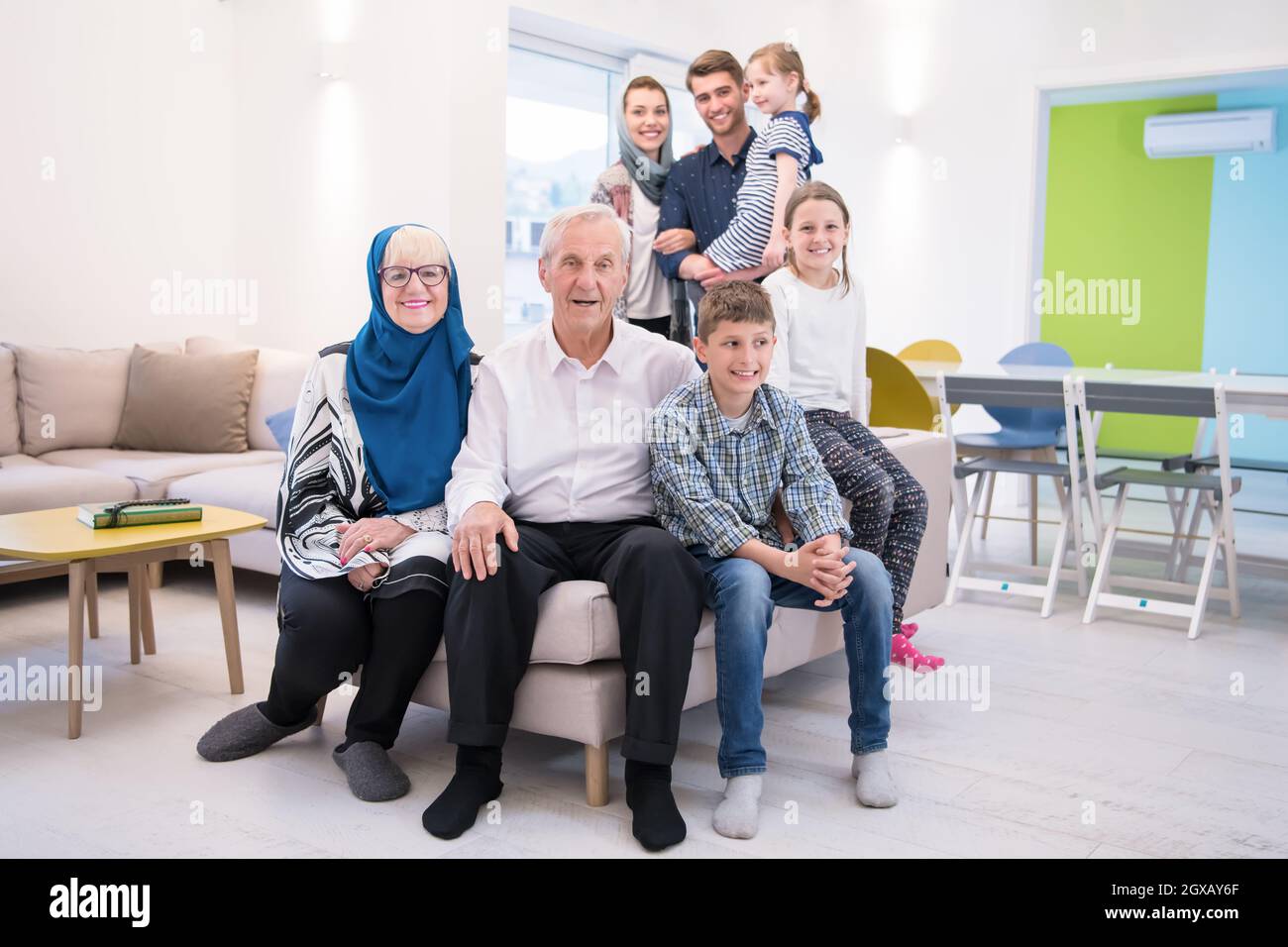 several generations portrait of happy modern muslim family before iftar ...