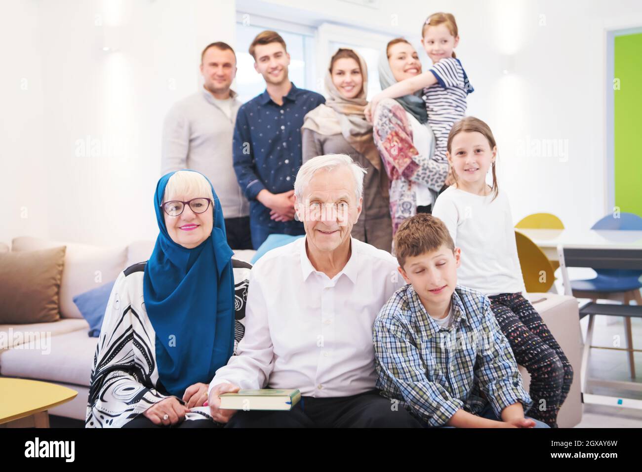 several generations portrait of happy modern muslim family before iftar ...