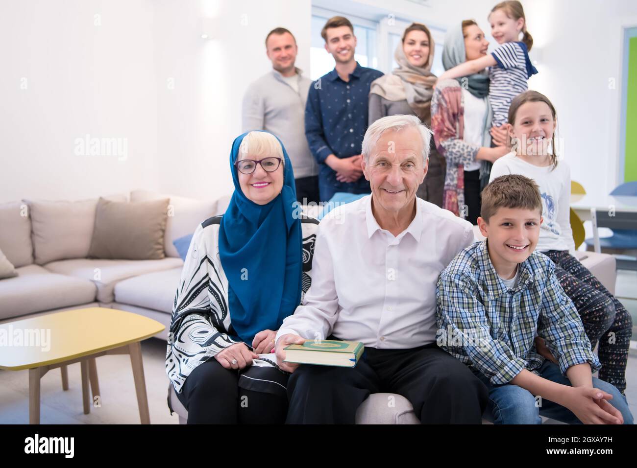 several generations portrait of happy modern muslim family before iftar ...