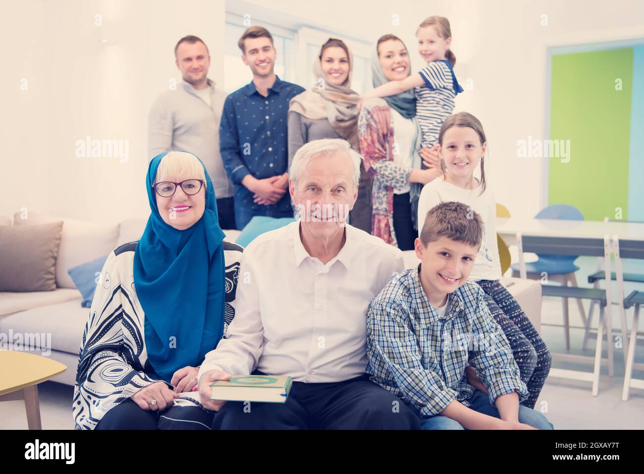 several generations portrait of happy modern muslim family before iftar ...