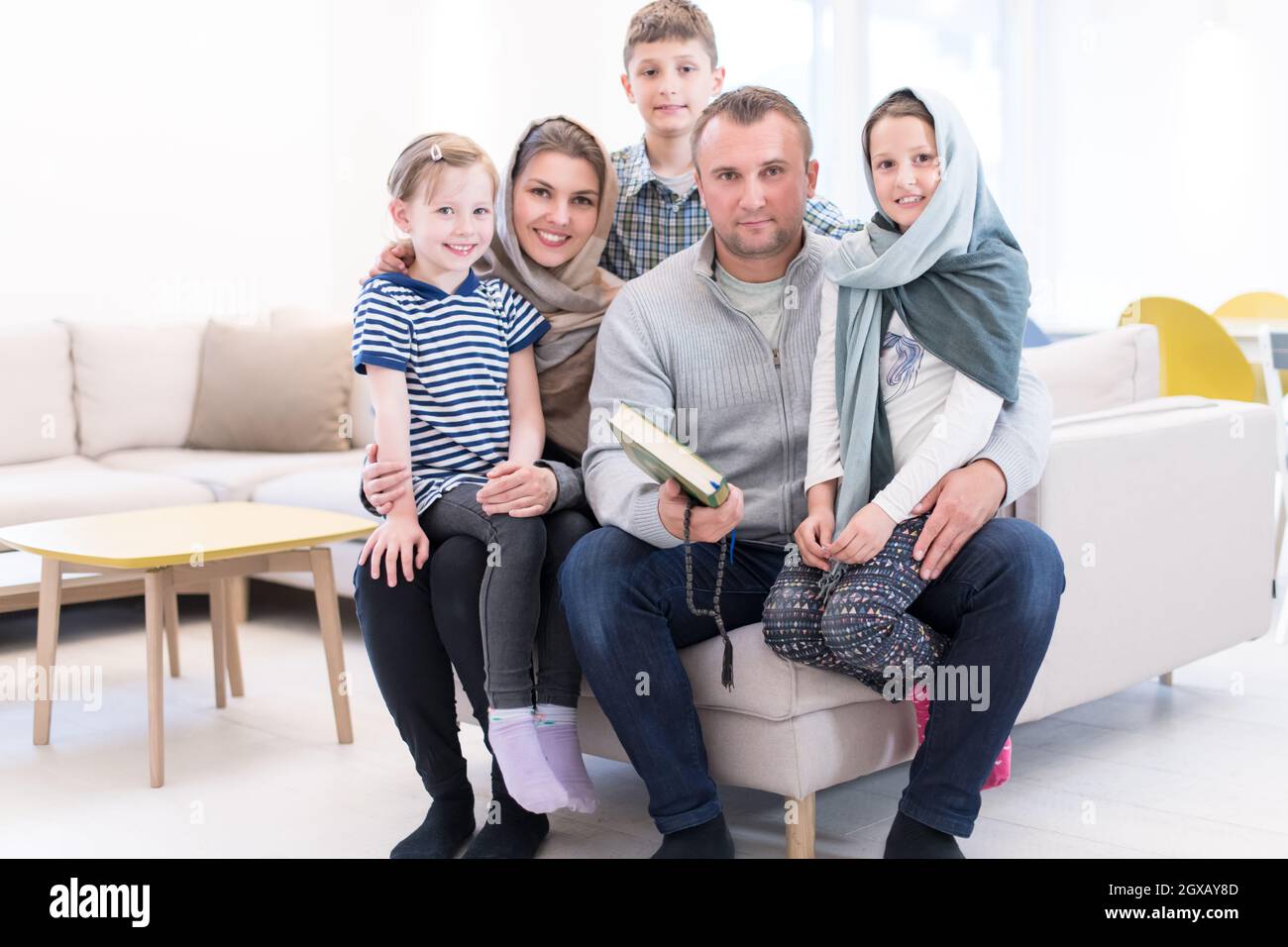 portrait of young happy modern muslim family before iftar dinner during ...