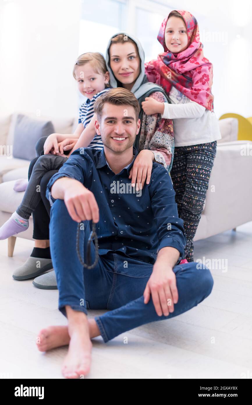 portrait of young happy modern muslim family before iftar dinner during ...
