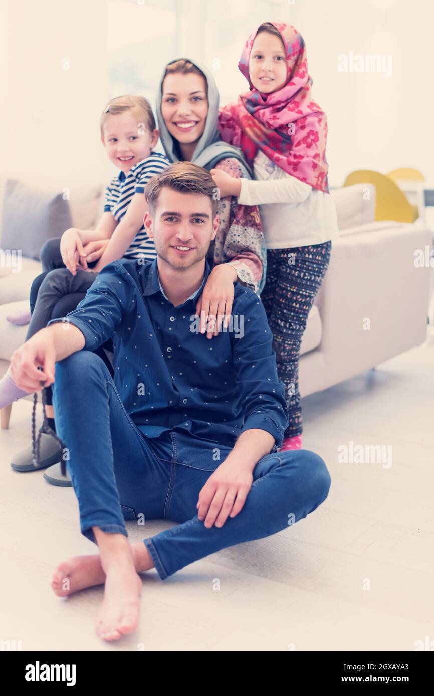 portrait of young happy modern muslim family before iftar dinner during ...