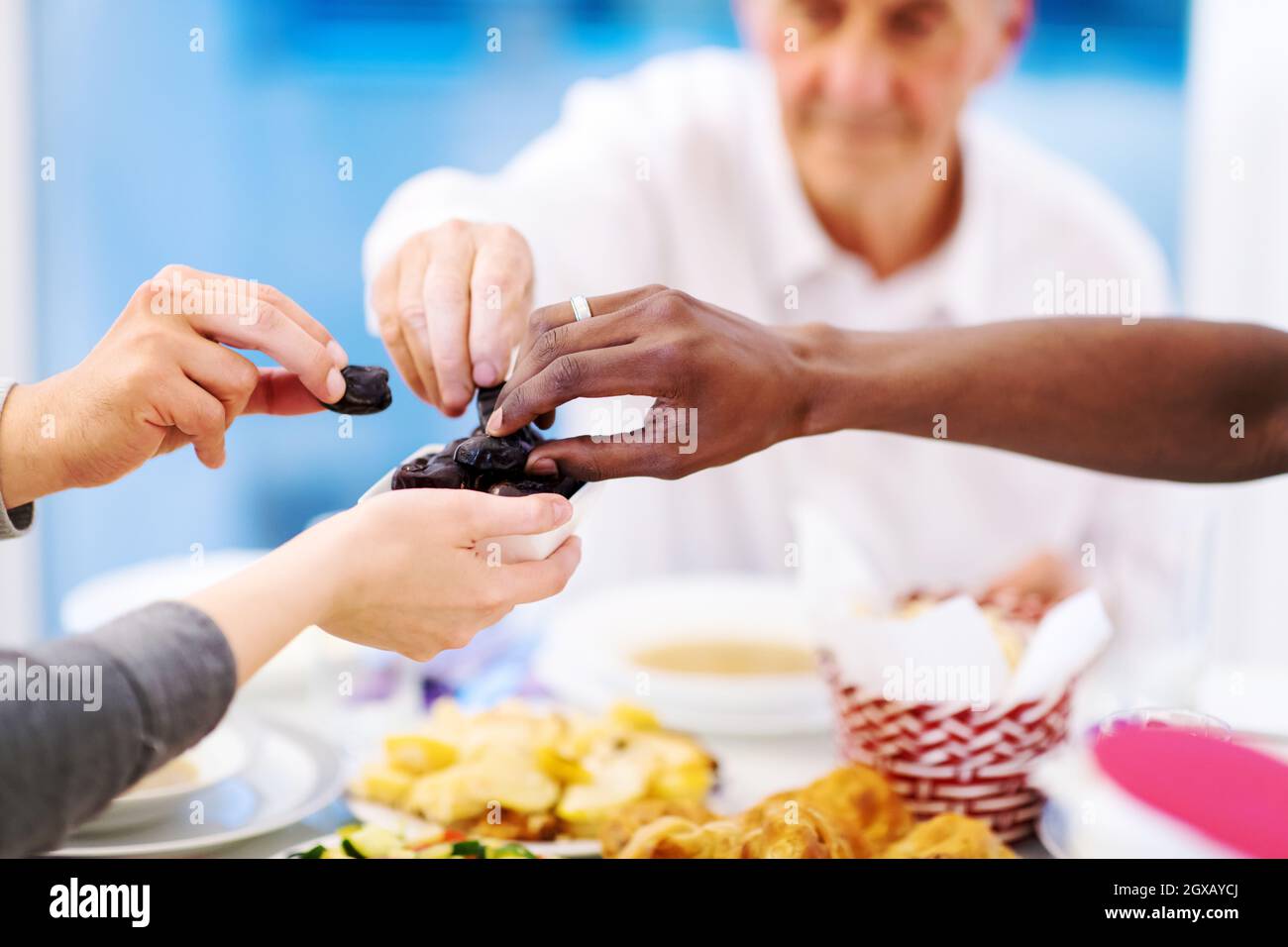 modern multiethnic muslim family sharing a bowl of dates while enjoying ...